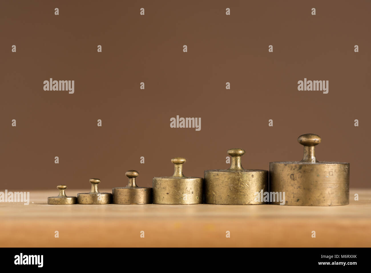 Old brass weights for a kitchen scale standing on a table Stock Photo ...