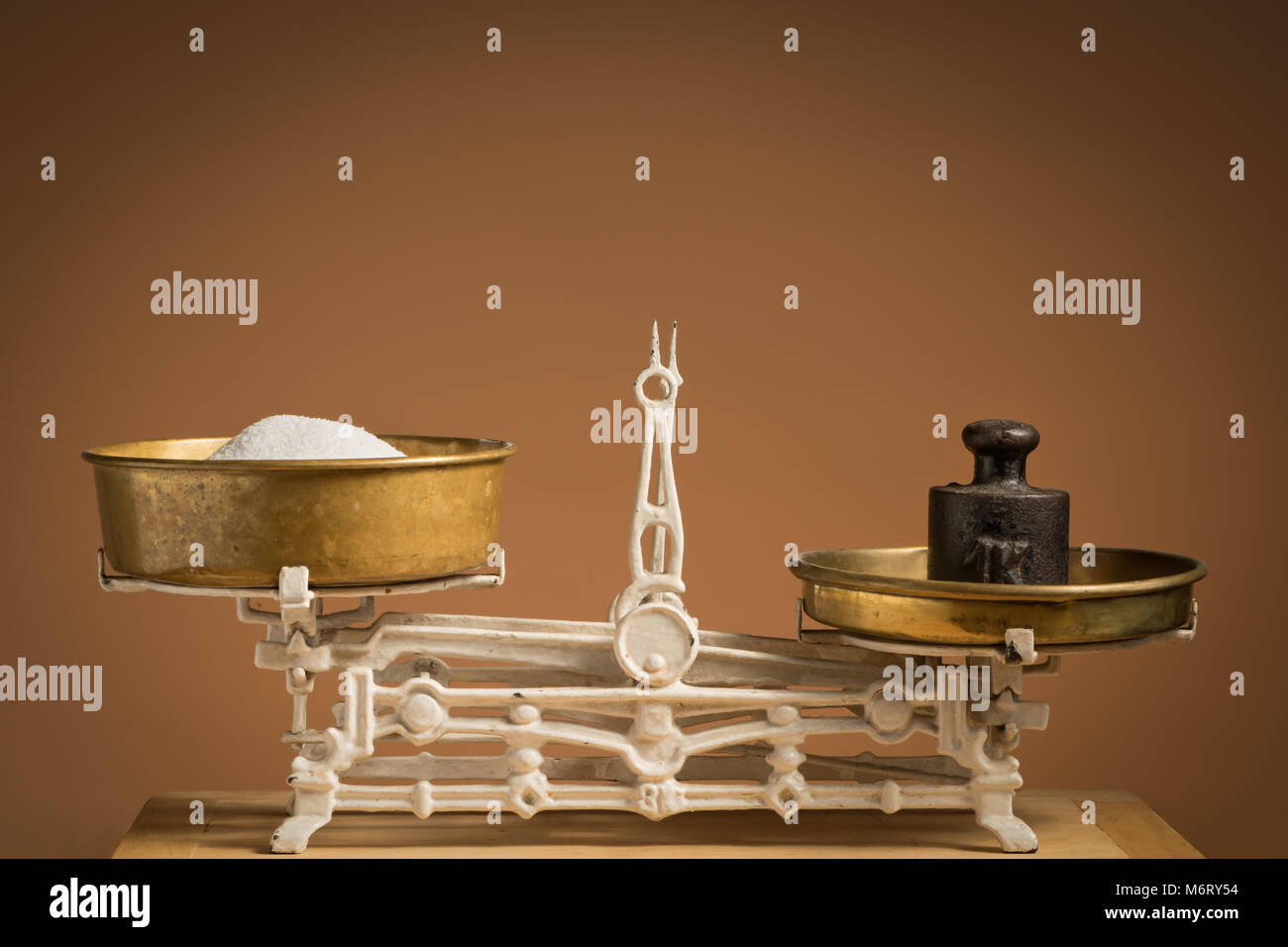 Old white vintage kitchen scale, brass with weights and sugar on a ...