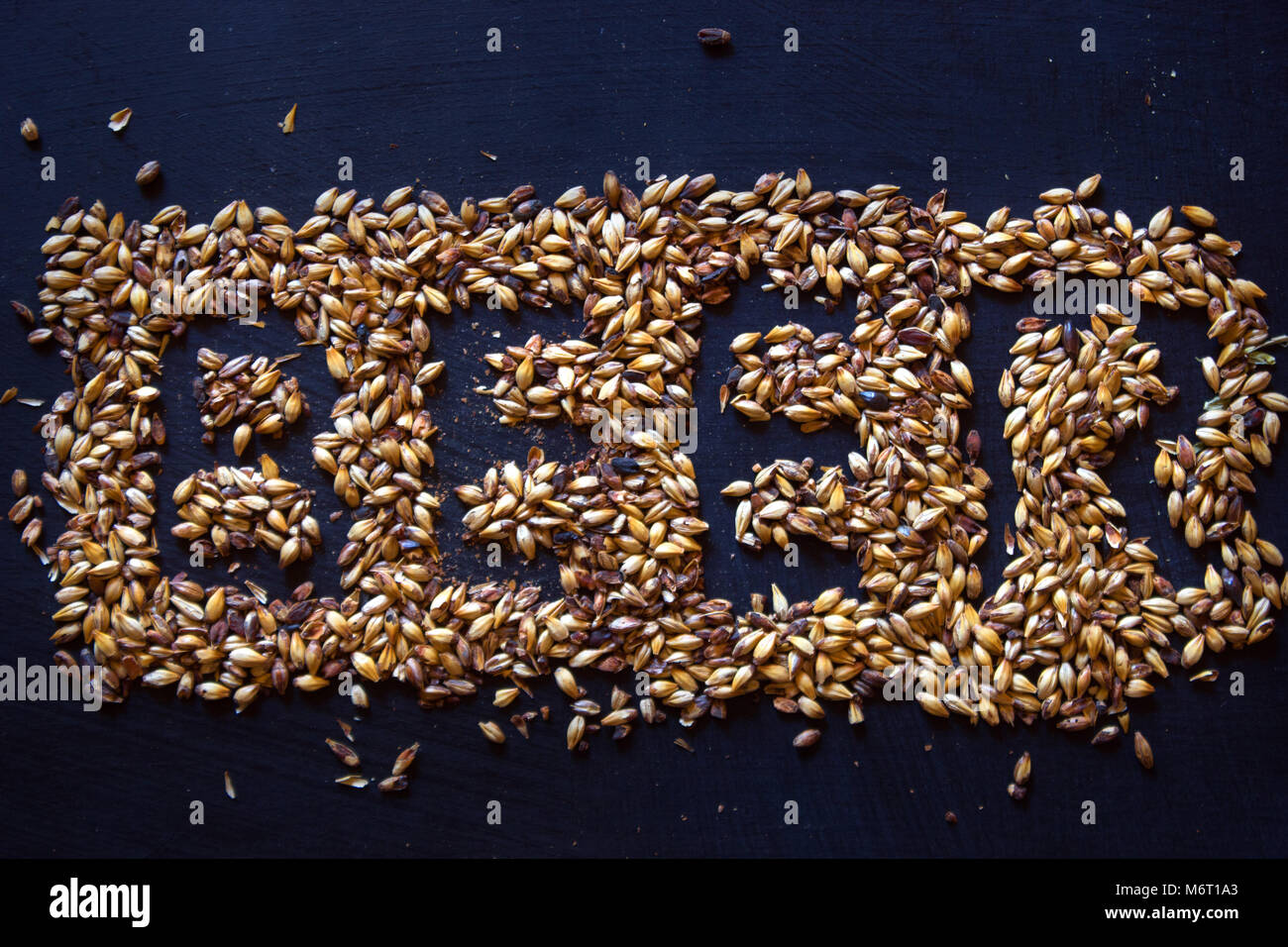 top view beer word formed by malt barley grains on blackboard Stock ...