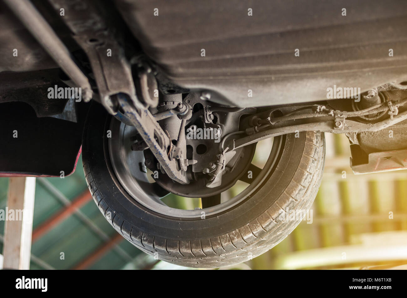 Close up tire wheel bush-bolt under double wishbone suspension car lift ...