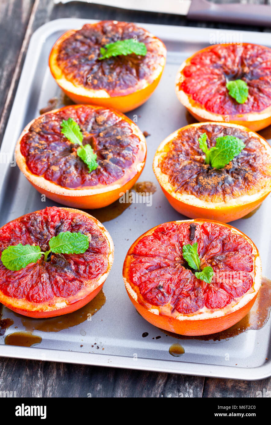 baked grapefruit with brown sugar and cinnamon on metal tray Stock ...