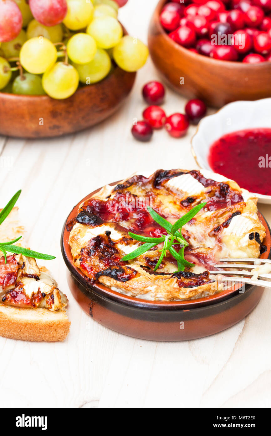baking camembert with cranberry sauce and rosemary served with toasted ...