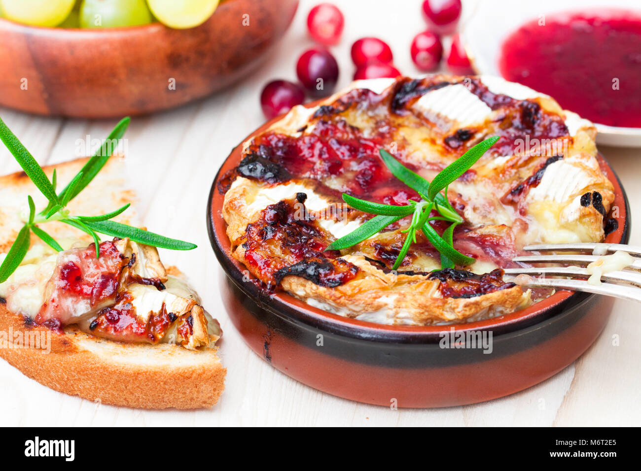 baking camembert with cranberry sauce and rosemary served with toasted ...