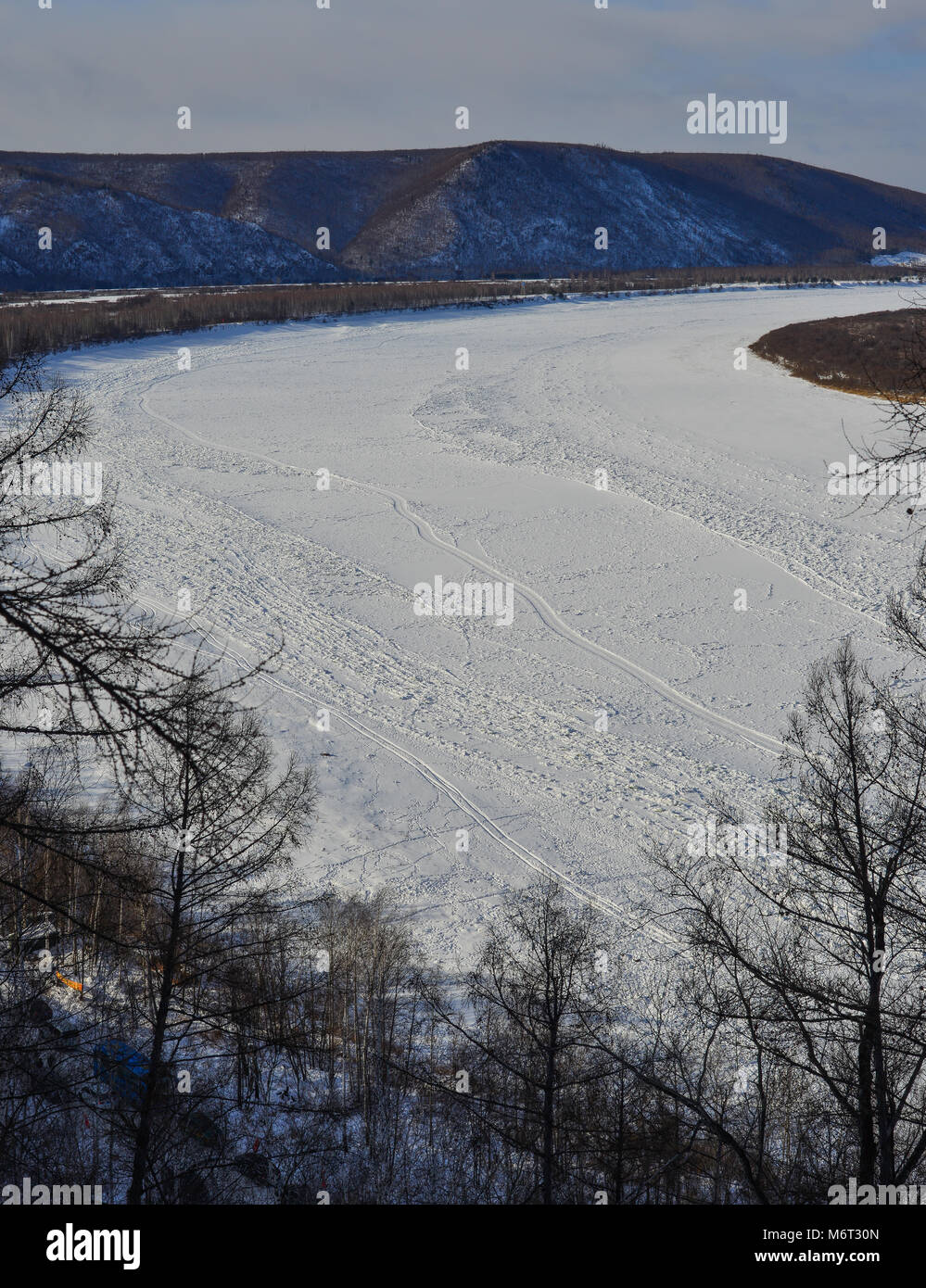 Ice river with forest at winter in Mohe County, China. Mohe is located ...