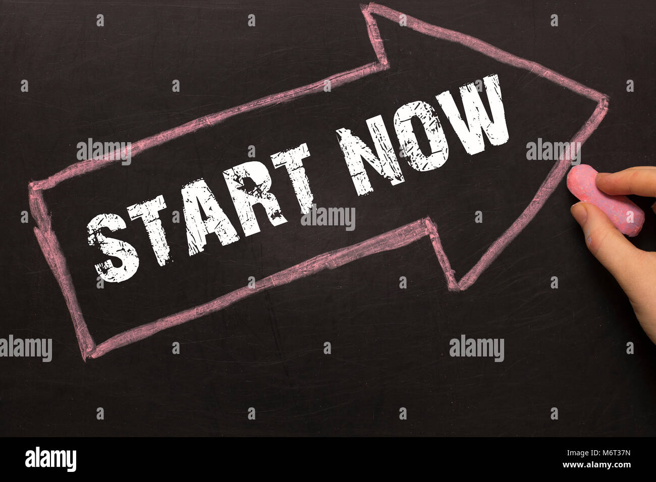 start now - Chalkboard with arrow on black background Stock Photo - Alamy