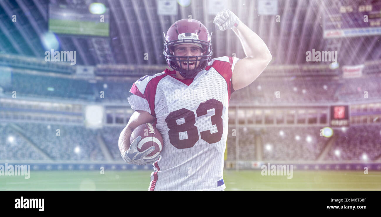 american football player celebrating touchdown on big modern stadium ...