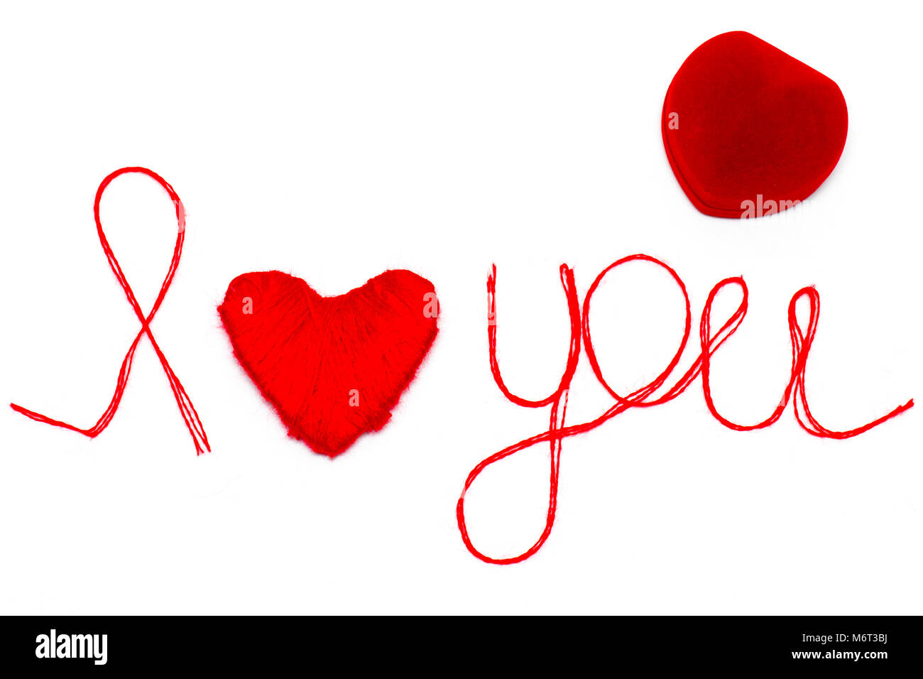 Love you words and heart symbol made of red thread on a white ...