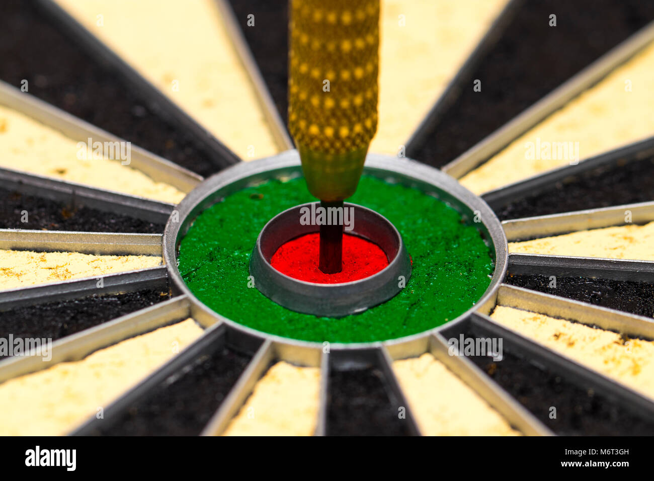 Dart arrow hitting in the target center of dartboard Stock Photo - Alamy