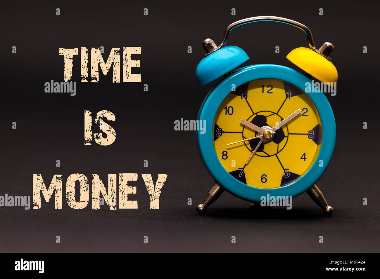 Time is Money written with alarm clock on black paper background Stock ...
