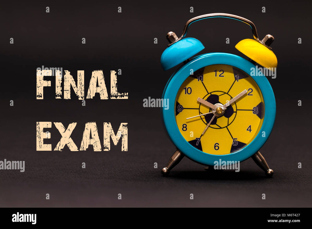 Concept,alarm clock with final exam phrase written on black background ...
