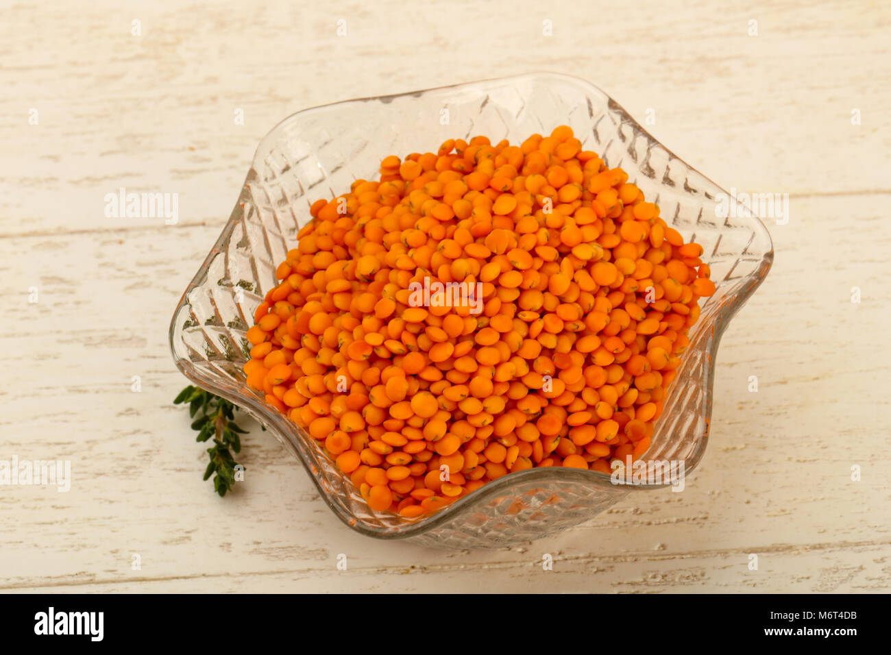 Orange lentil in the bowl over wooden background Stock Photo - Alamy