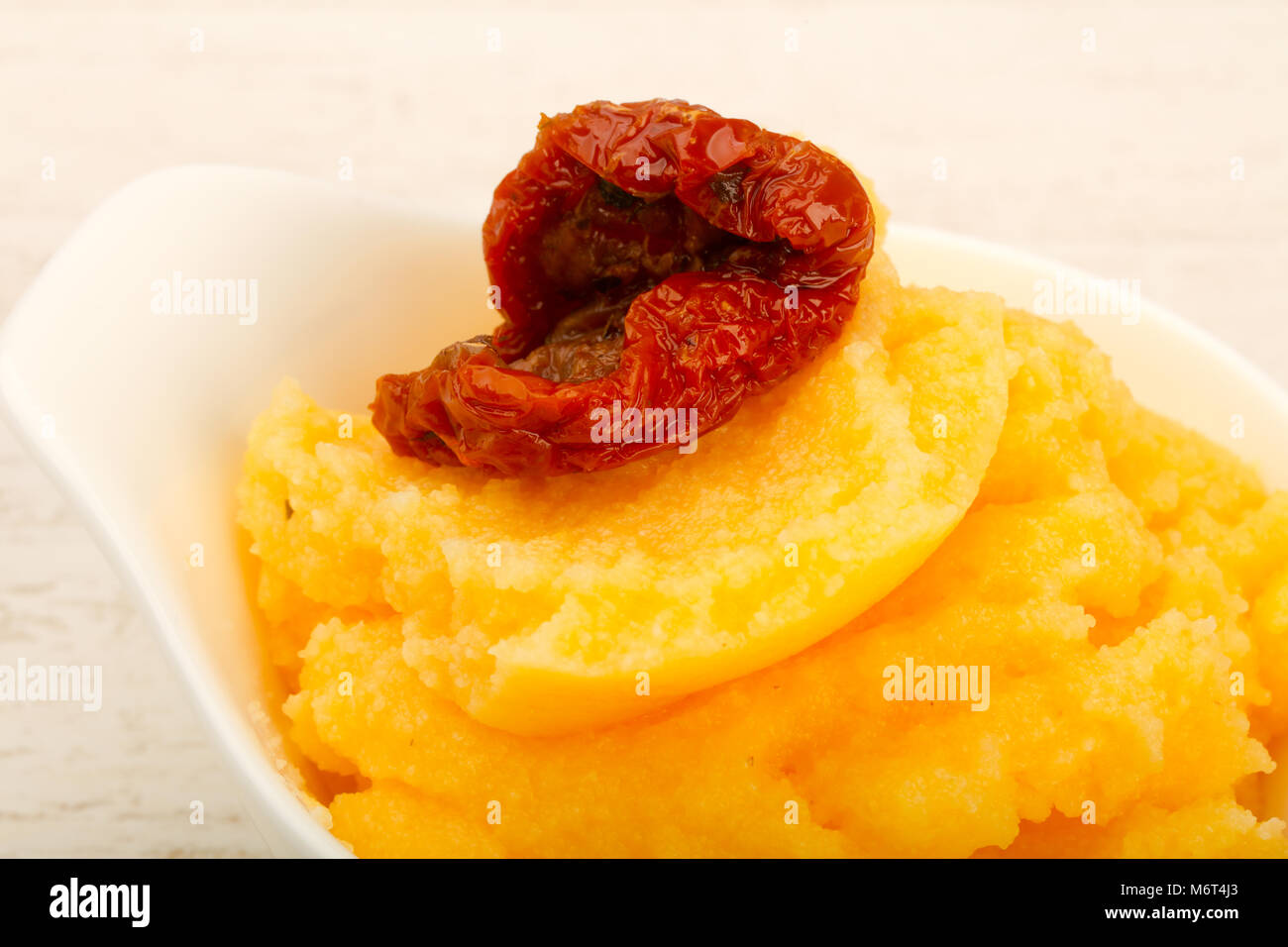 Polenta with dry tomato Stock Photo - Alamy