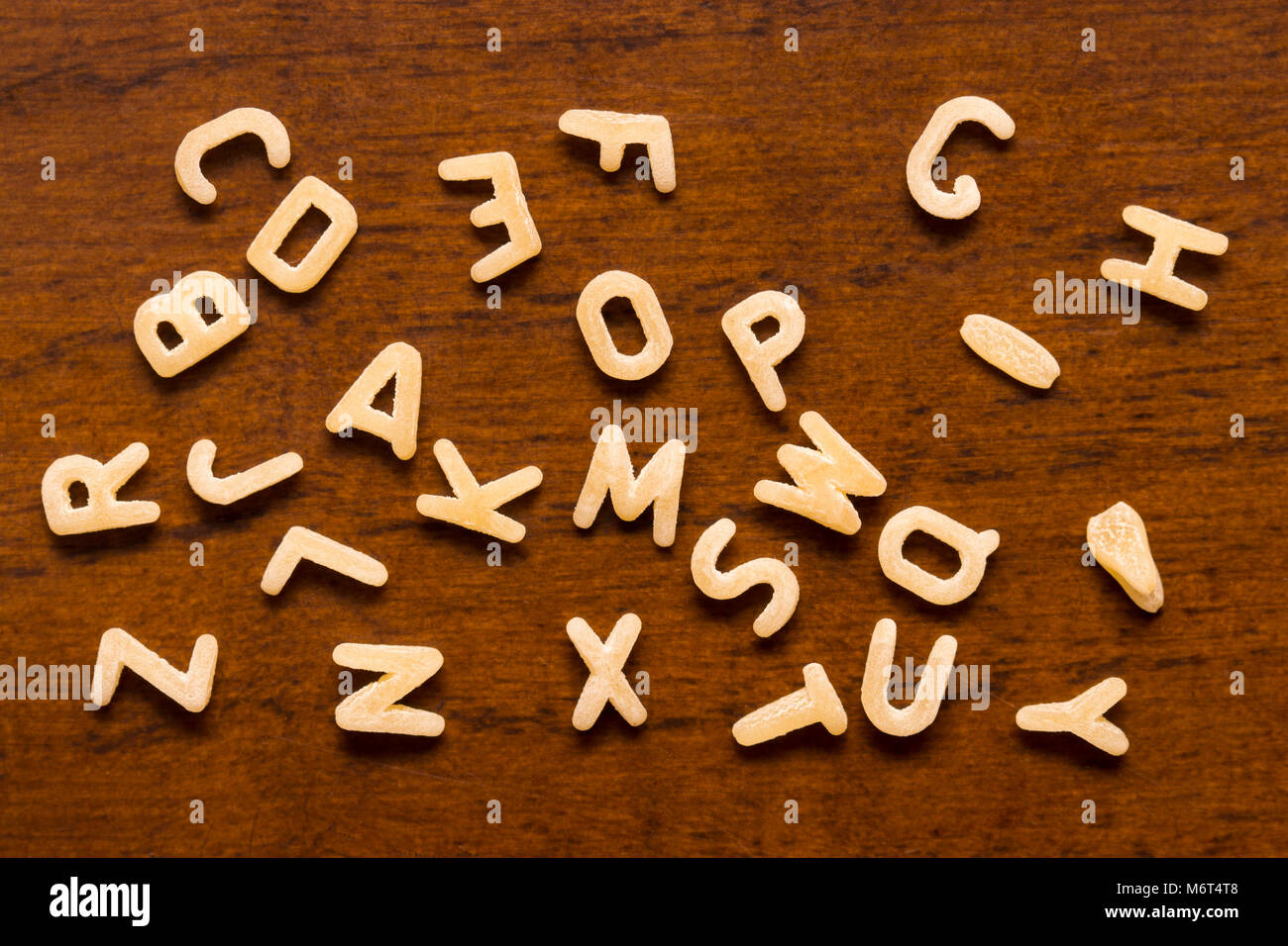 Alphabet made of macaroni letters isolated on wood background Stock ...