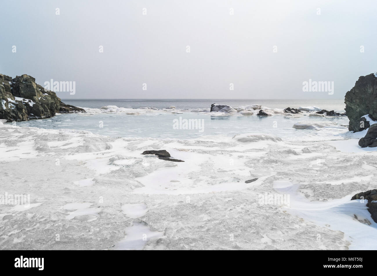 A lot of ice floes float in the sea meltwater in a picturesque bay ...