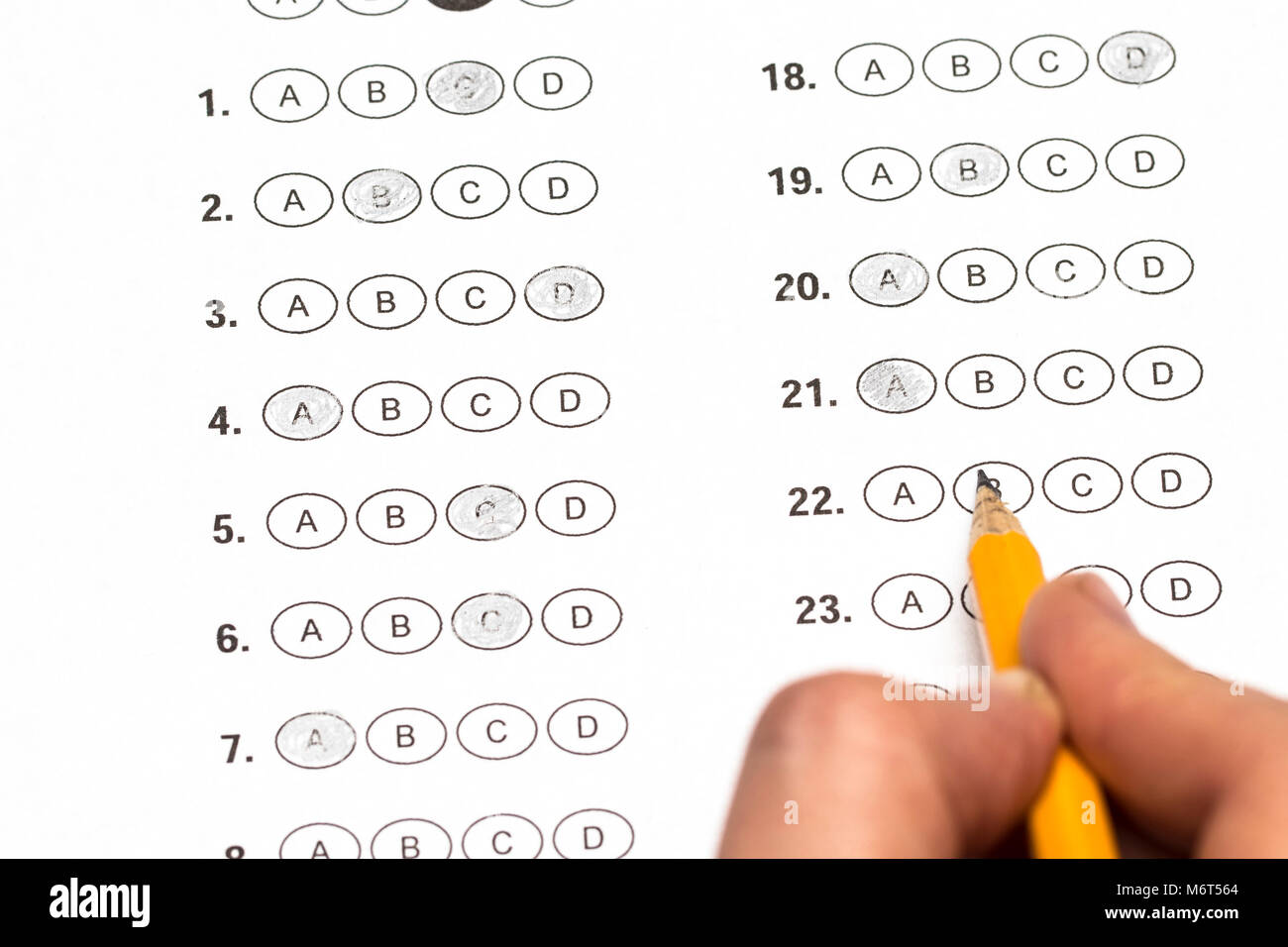 hand fill in Exam papers sheet and pencil Stock Photo - Alamy