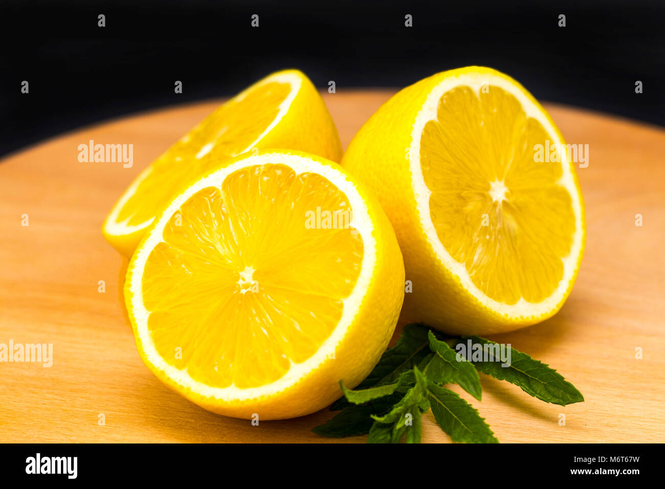 Half of lemon on a wooden board. Lemons on a wooden background. Lemons ...
