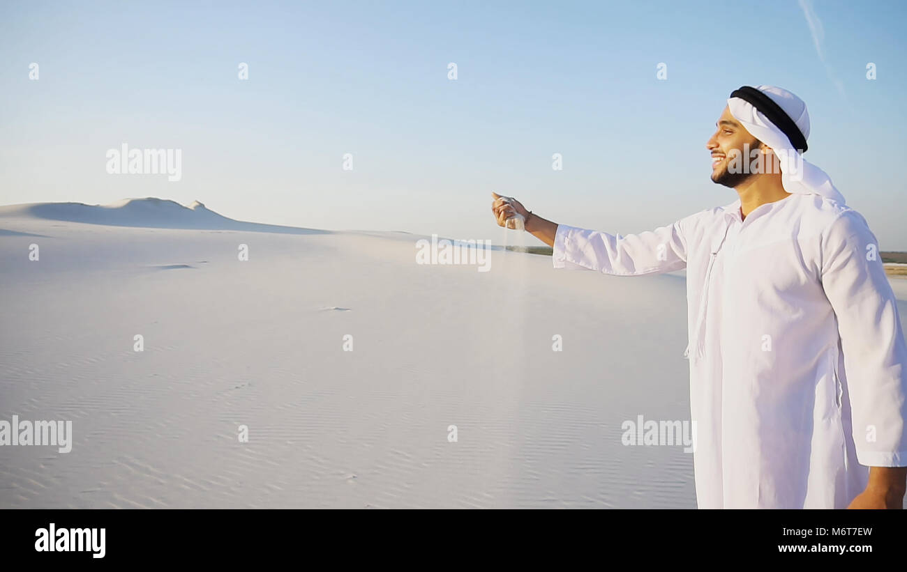 Joyful Arabian Sheikh man walks on top of desert with smile on f Stock ...