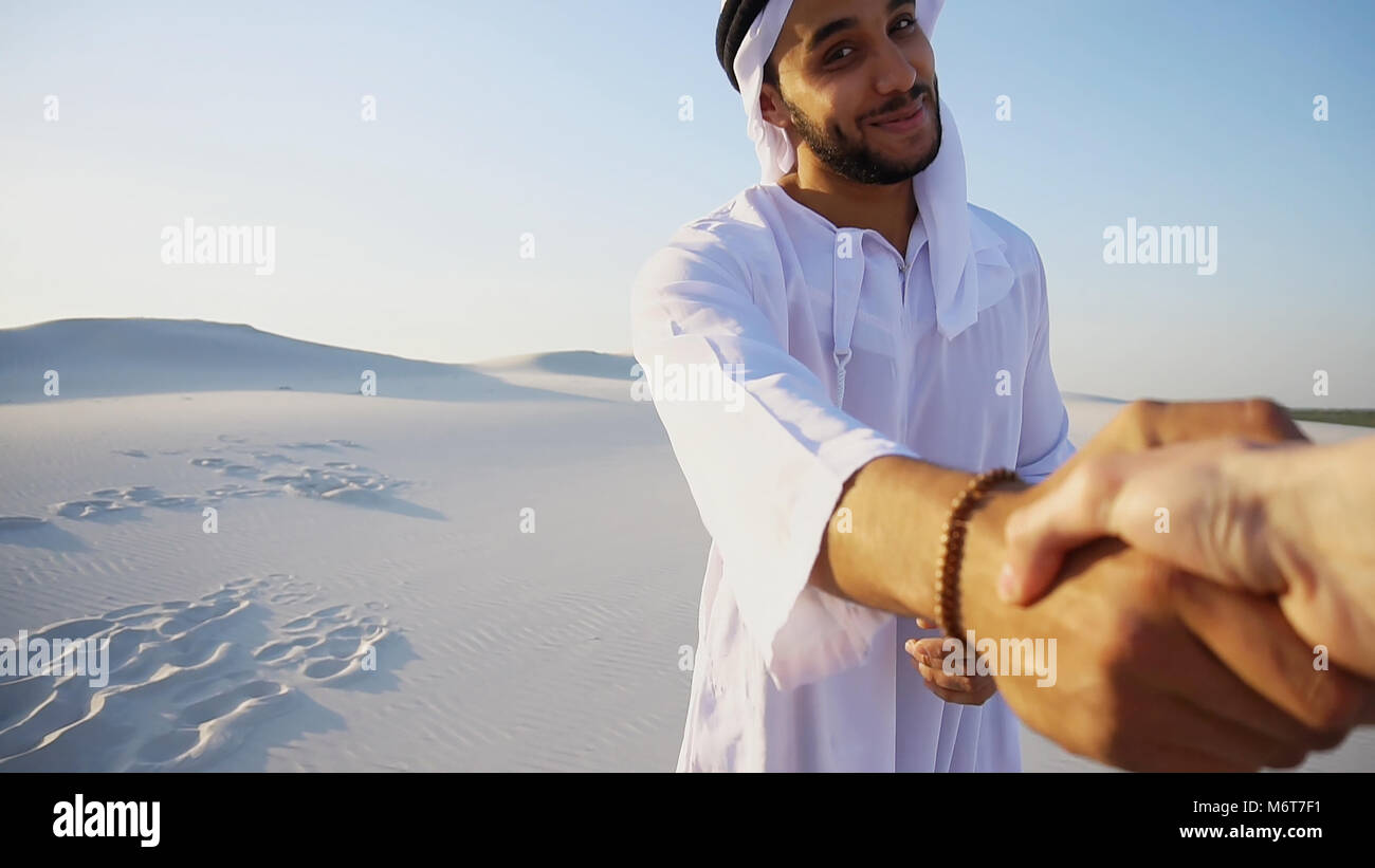 Young Arabian guide guides girl's hand and conducts conversation Stock ...