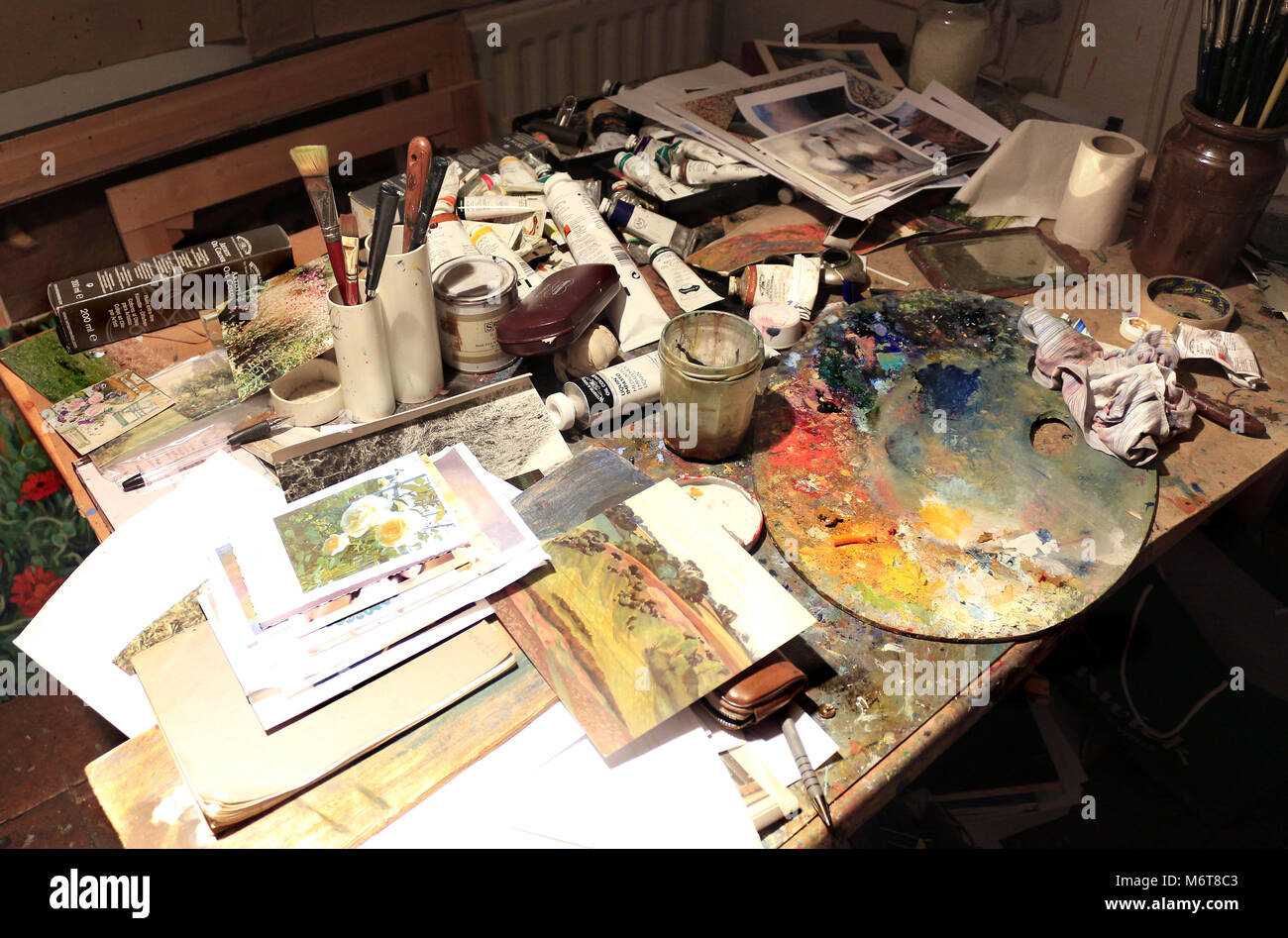 Artist' table with arts materials Stock Photo - Alamy