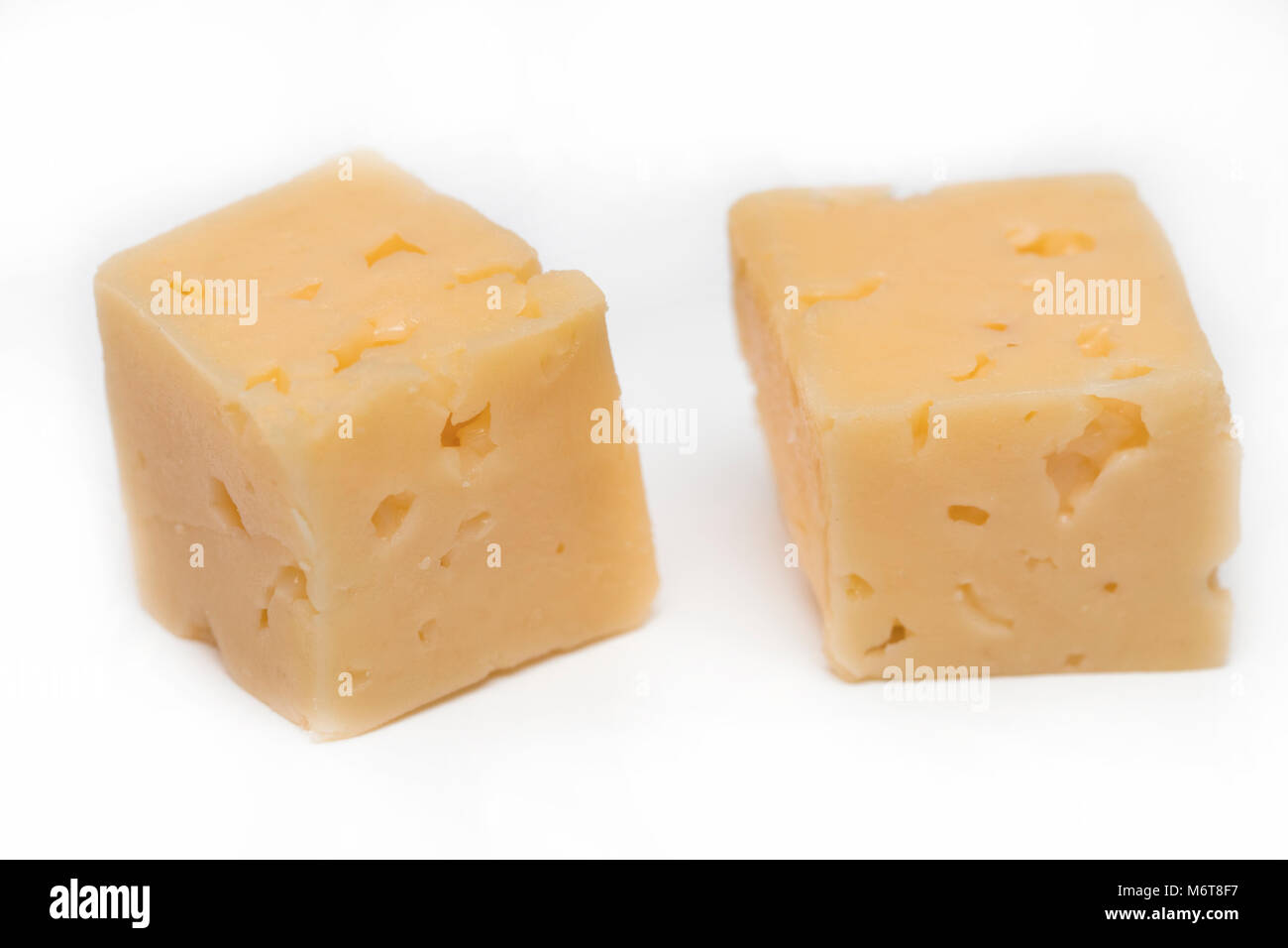 Cube of cheese isolated on a white background Stock Photo - Alamy