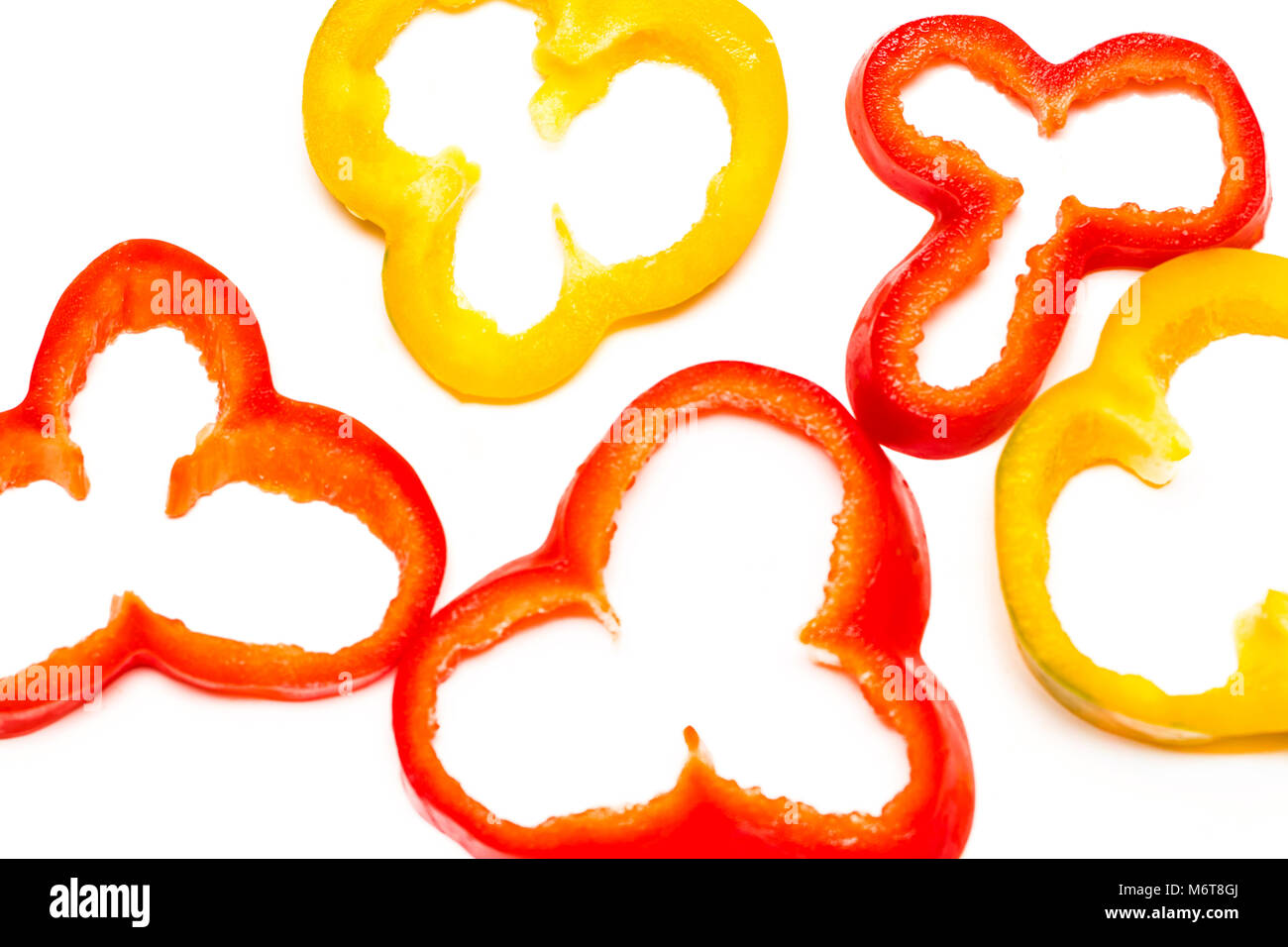 Red and yellow sweet pepper slices isolated on white background Stock ...