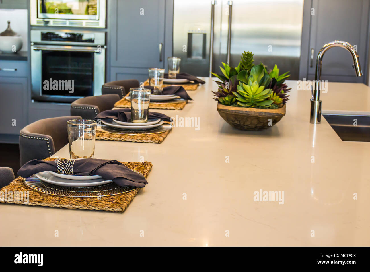 Place Setting For Four On Modern Kitchen Counter Stock Photo - Alamy