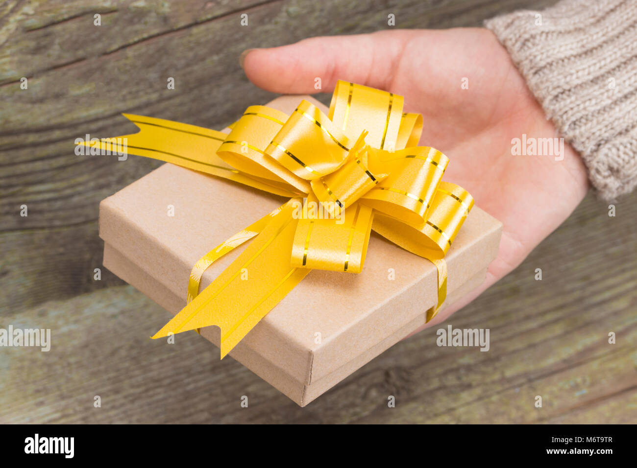 Close-up of female hand holding a present Stock Photo - Alamy