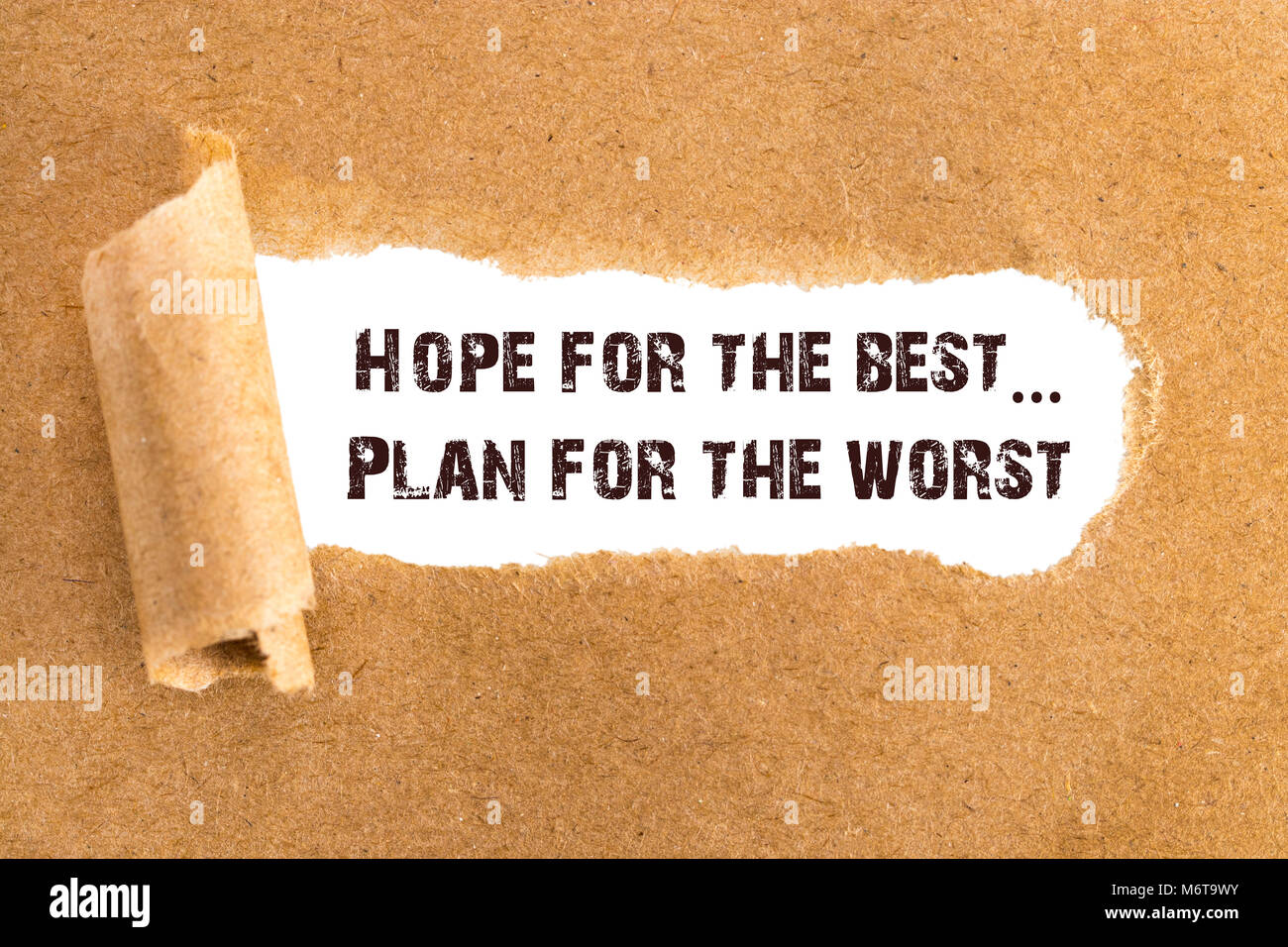 The text Hope for the best Plan for the worst appearing behind torn ...