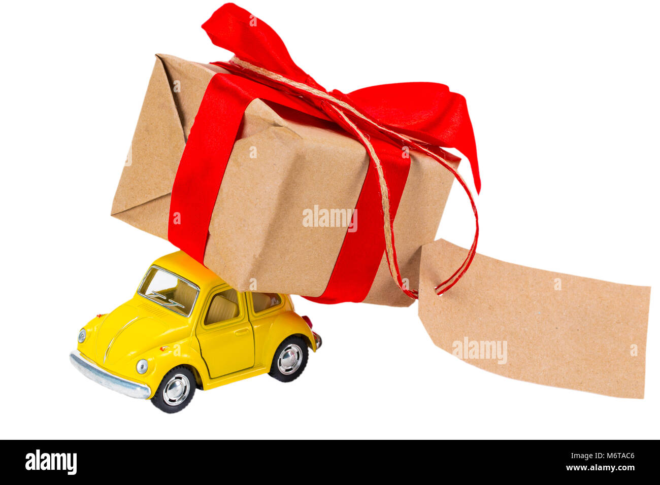 The Yellow retro toy car delivering gifts box with tag with empty space ...