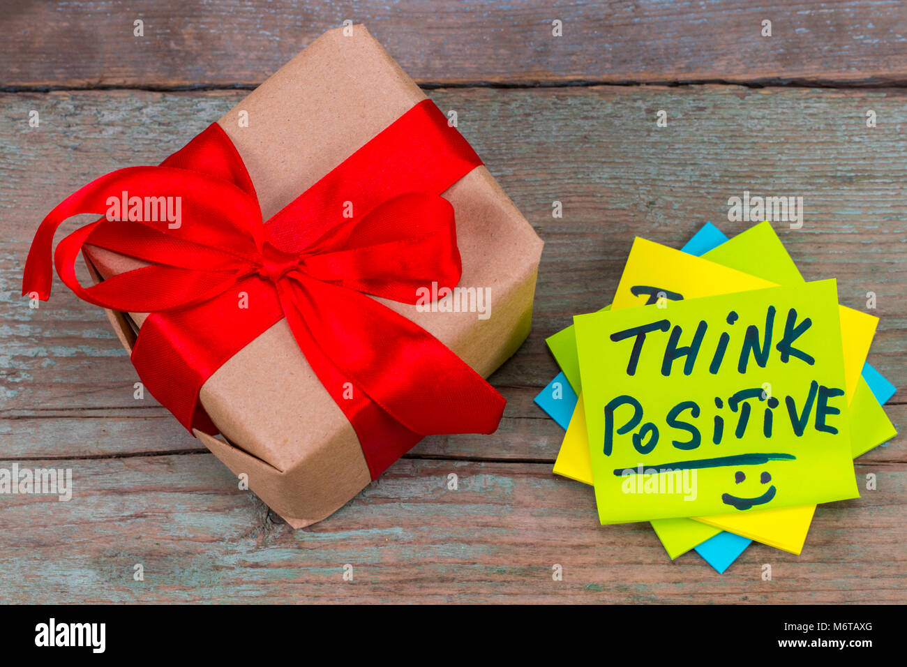 think positive - inspirational handwriting in a green sticky note and ...