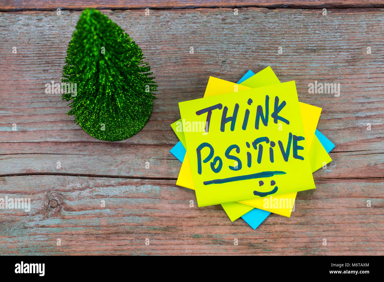 think positive - inspirational handwriting in a green sticky note and ...