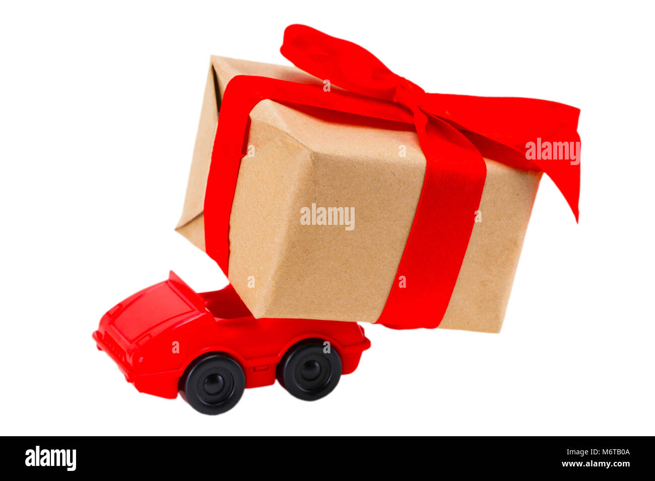 Red toy car delivering gifts box on a white background Stock Photo - Alamy