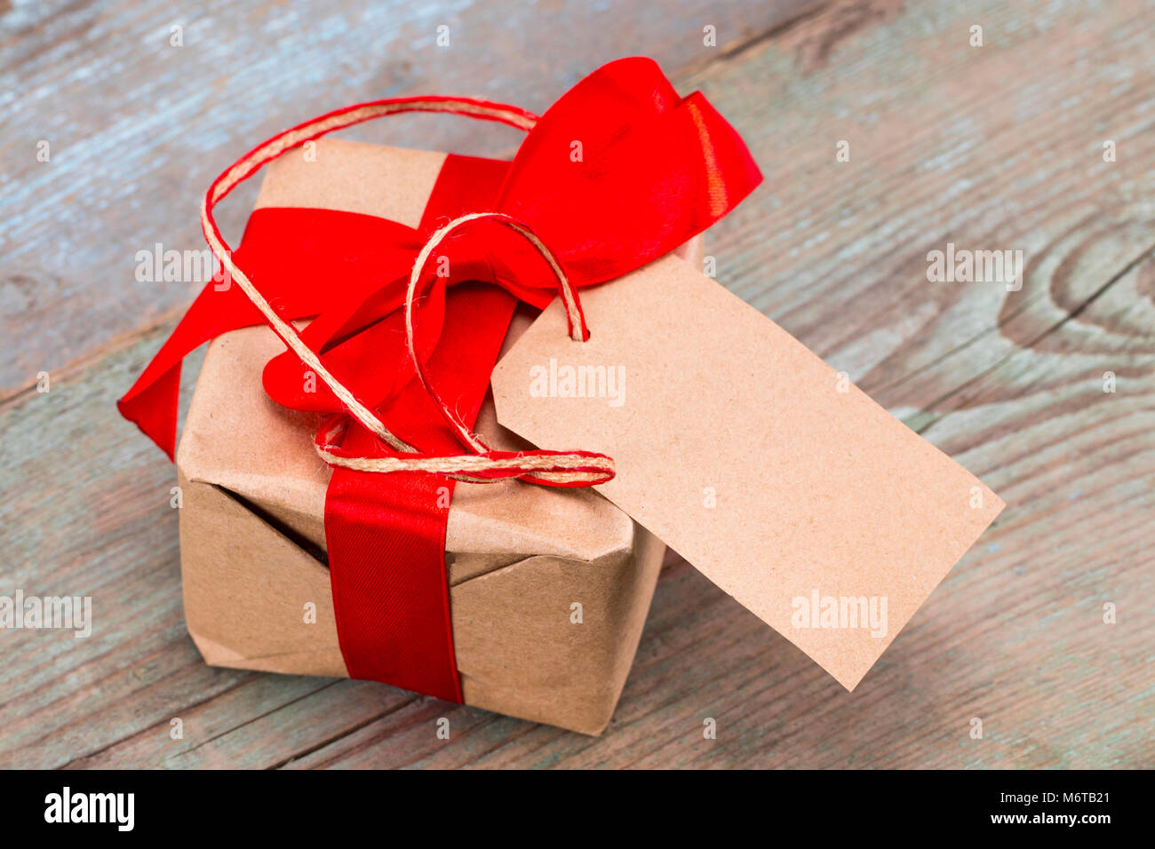 gift box with tag with empty space for a text on wooden background ...