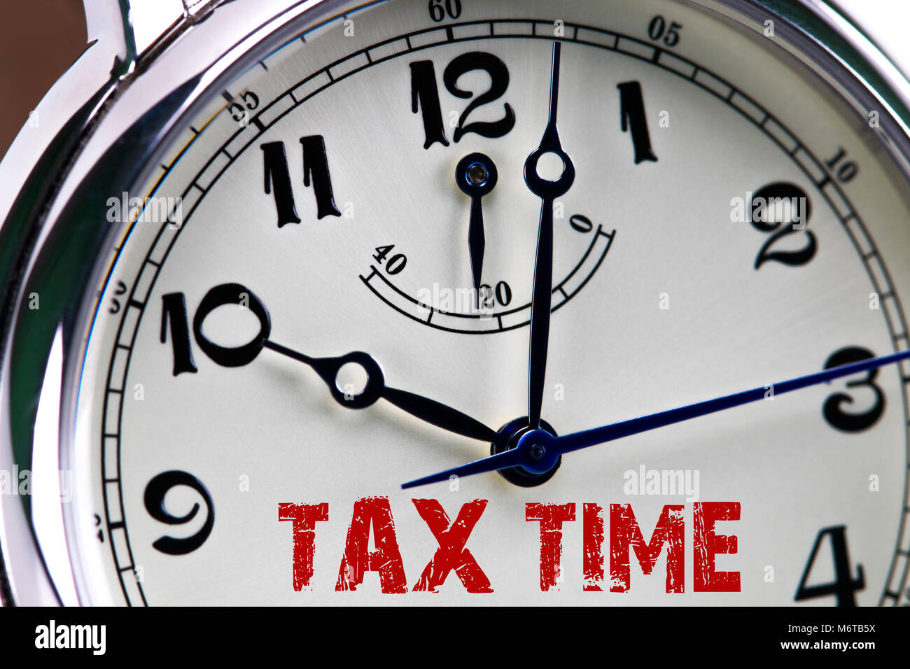 tax time concept clock closeup isolated on white background with red ...