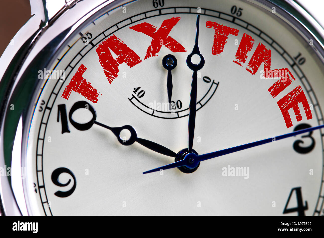 tax time concept clock closeup isolated on white background with red ...