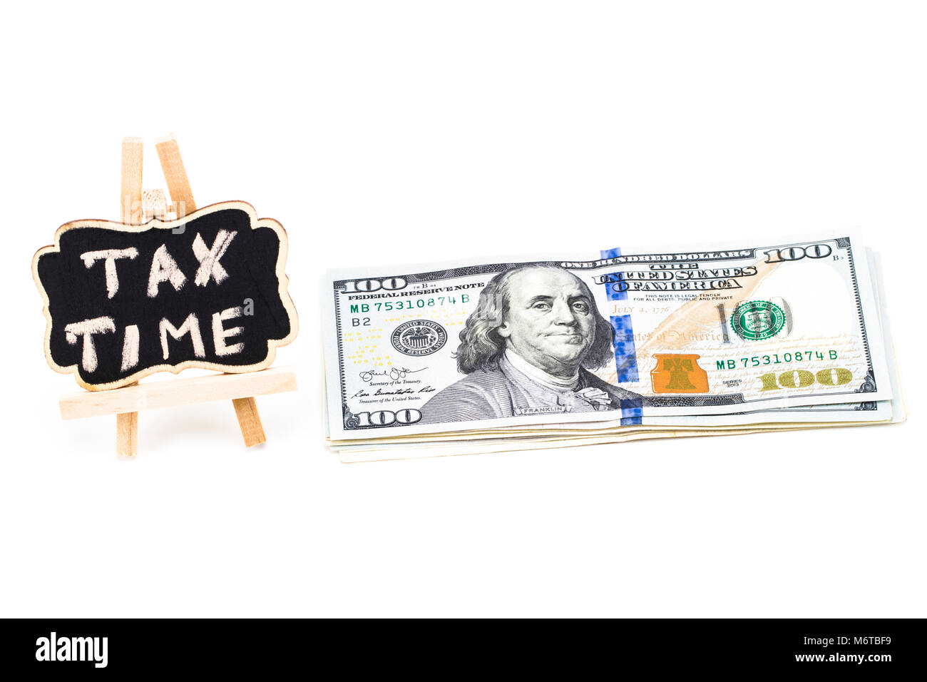 TAX TIME written on chalkboard with money on white background Stock ...