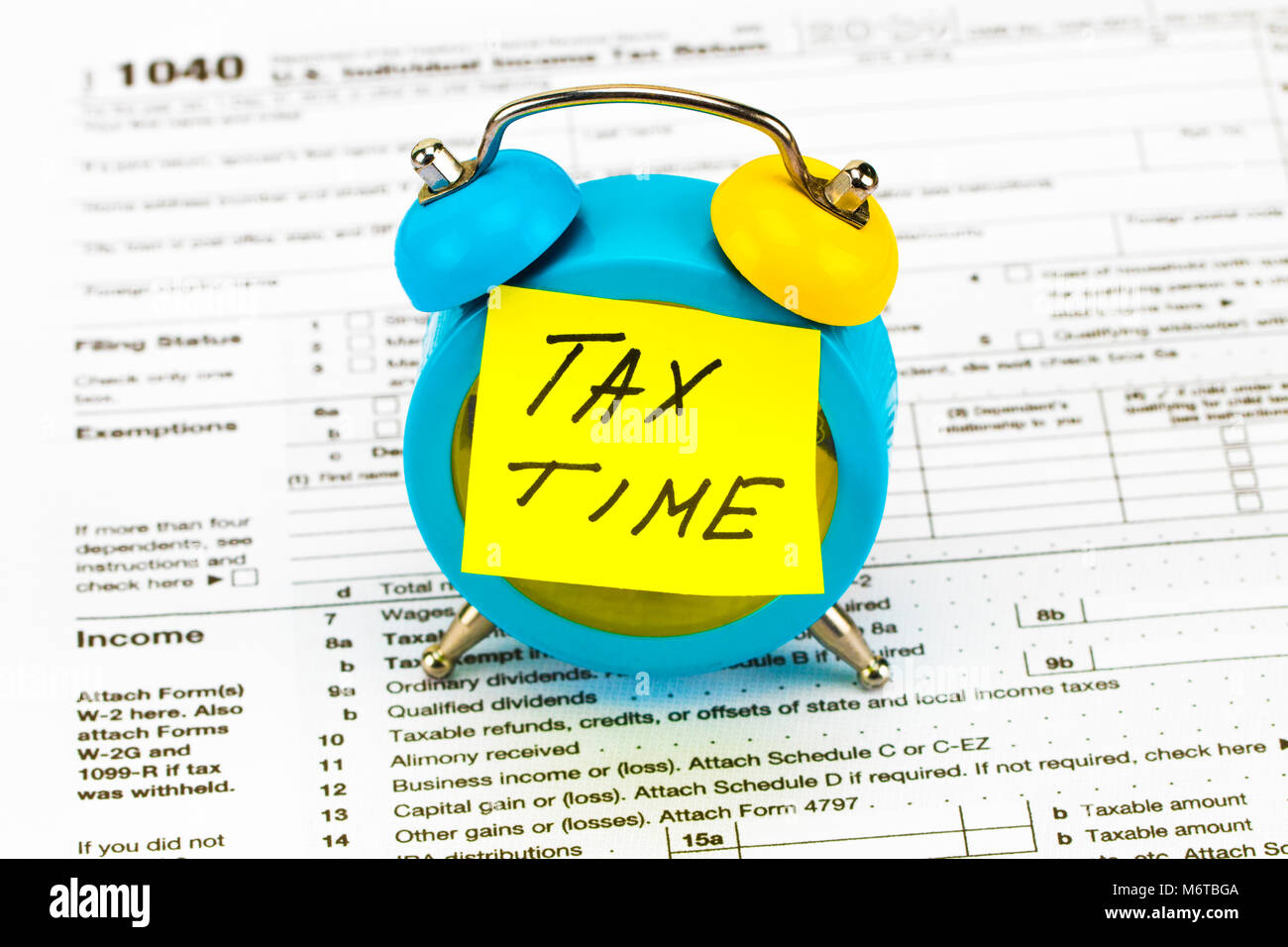 Tax Concept - A alarm clock with sticker note written TAX TIME with on ...