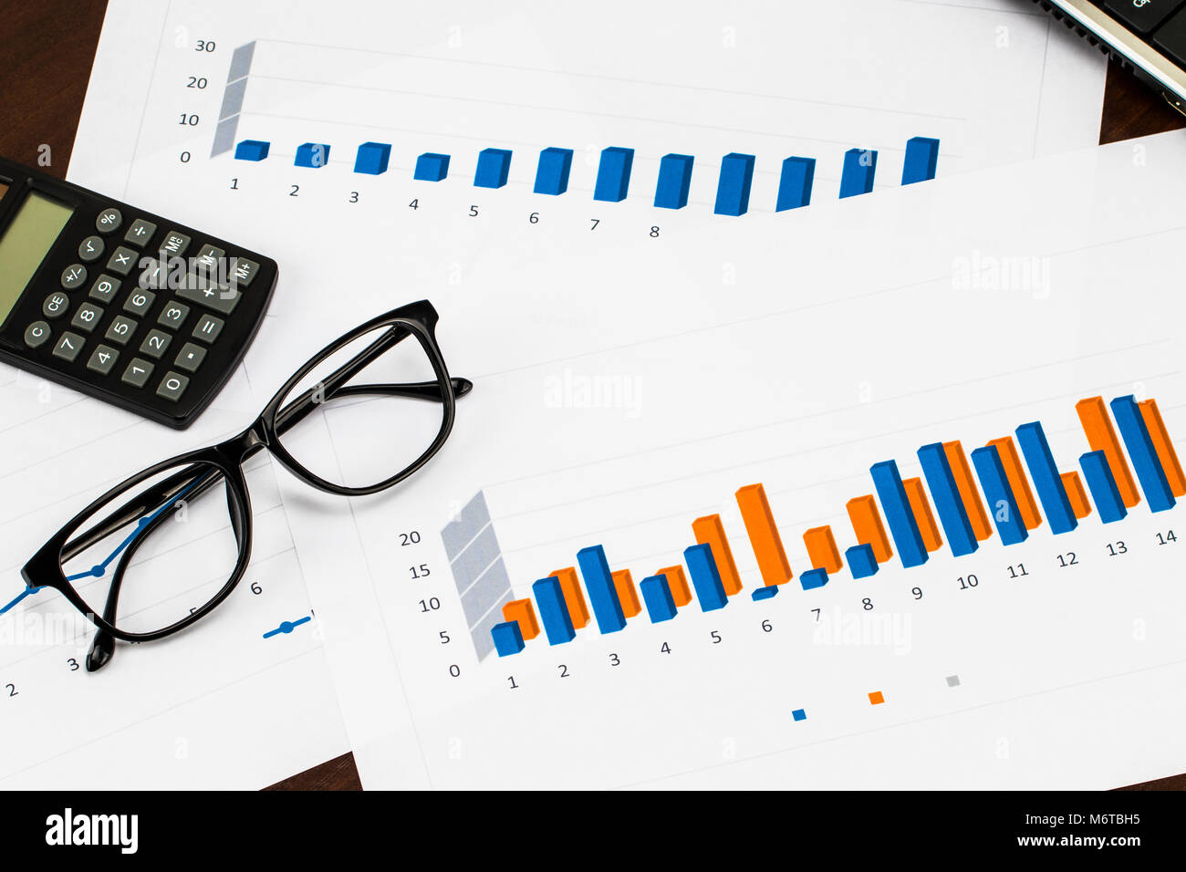 Preparing report. Blue graphs and charts. Business reports and pile of ...