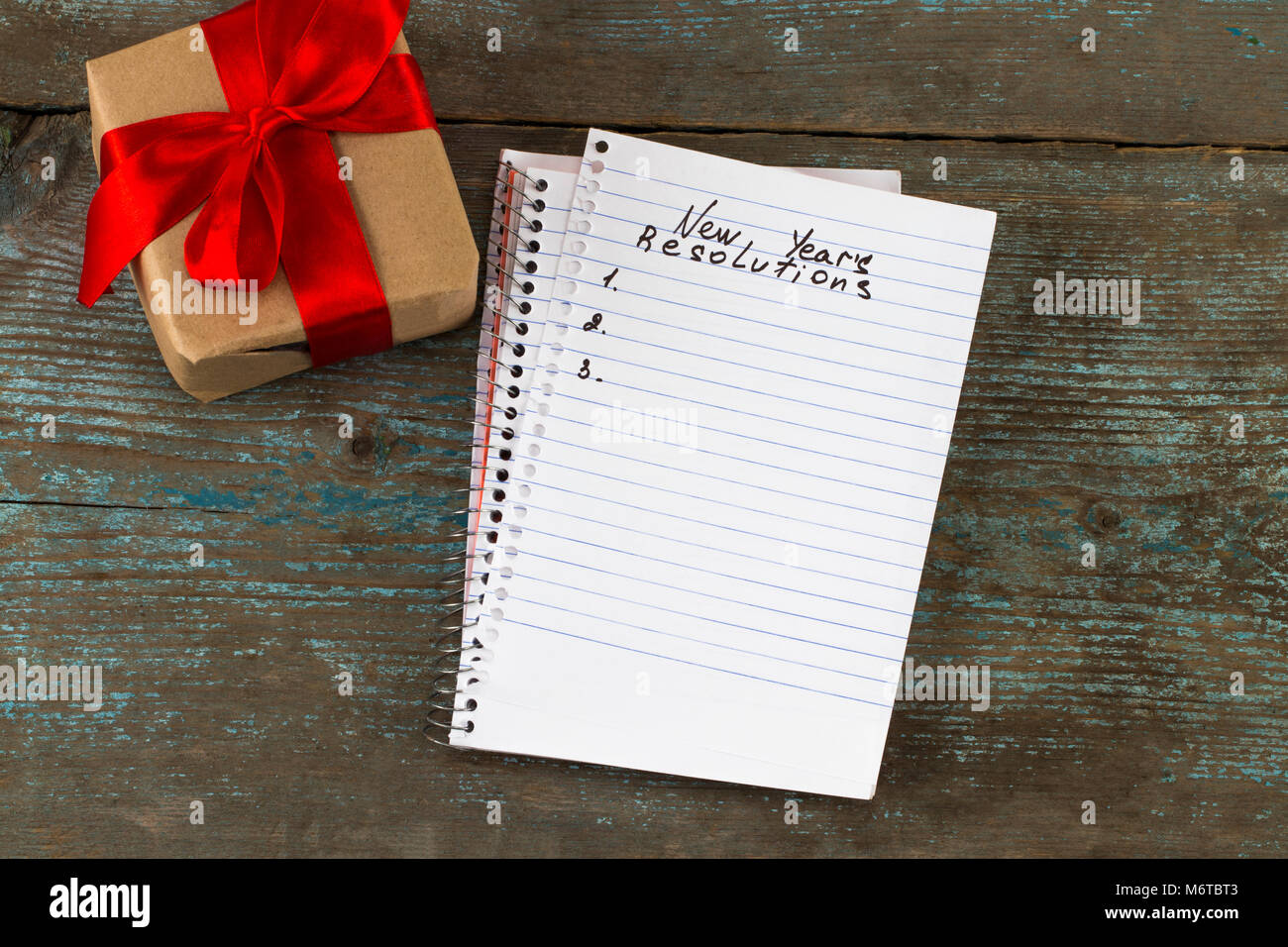 Resolutions text on notebook paper with gift box for business concept ...