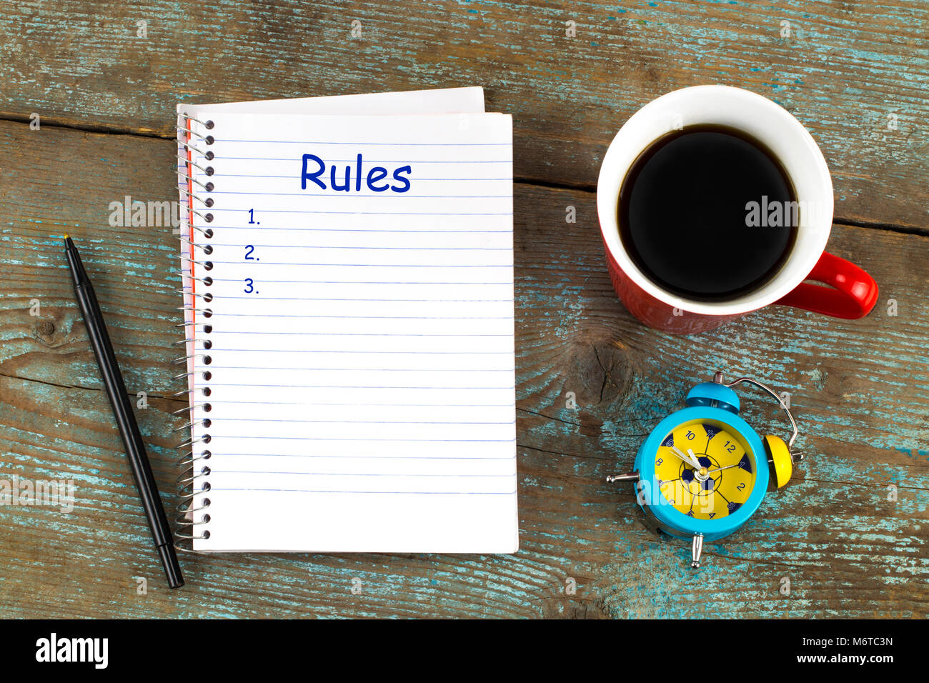 Rules list with notebook, cup of coffee on wooden desk. Top view Stock ...