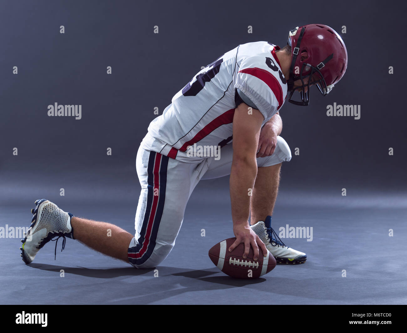 American football player getting ready before starting the game while ...