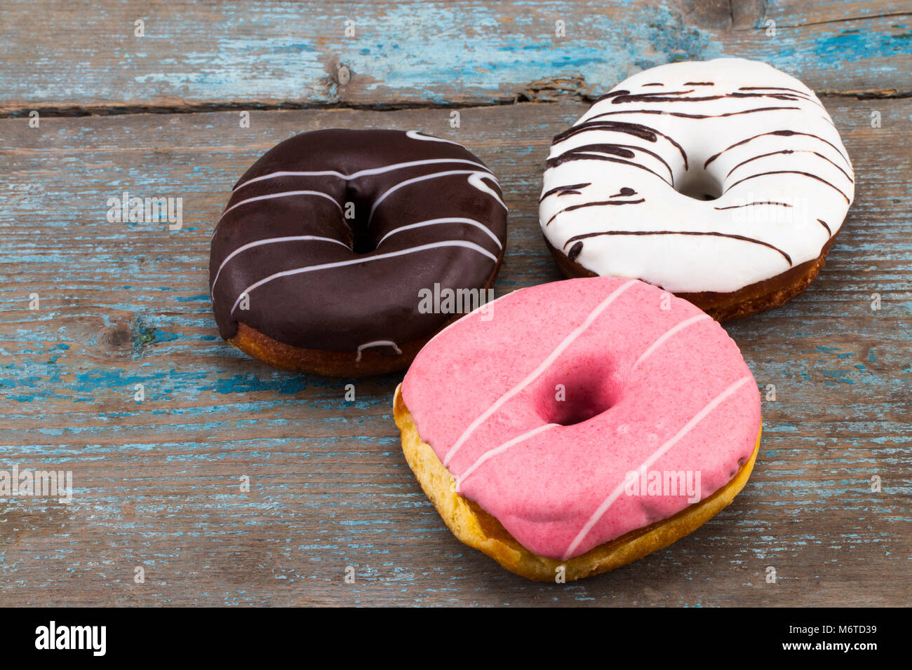 assorted donuts with chocolate frosted, pink glazed donuts Stock Photo ...
