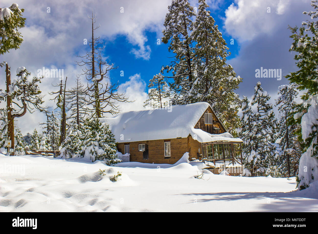 Remote Cabin At Top Of Hill With Snow On Roof Stock Photo - Alamy