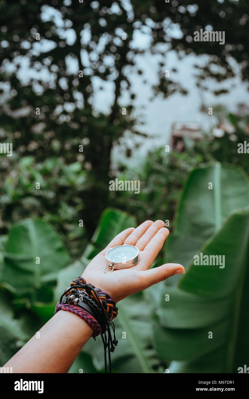 Hand with compass in the lush rainforest jungle Stock Photo - Alamy