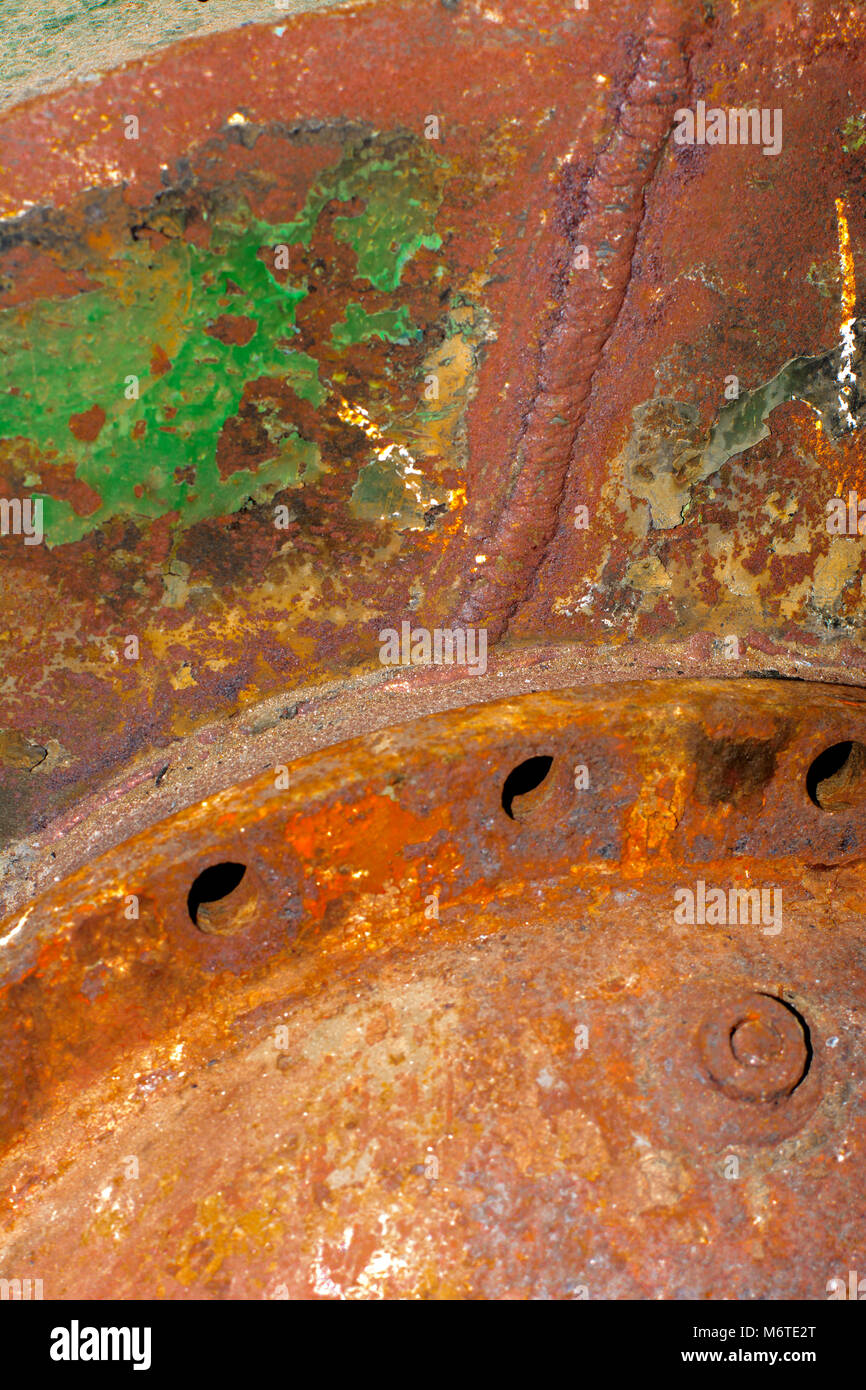 An old rusty stove for heating premises in winter in an abandoned and ...