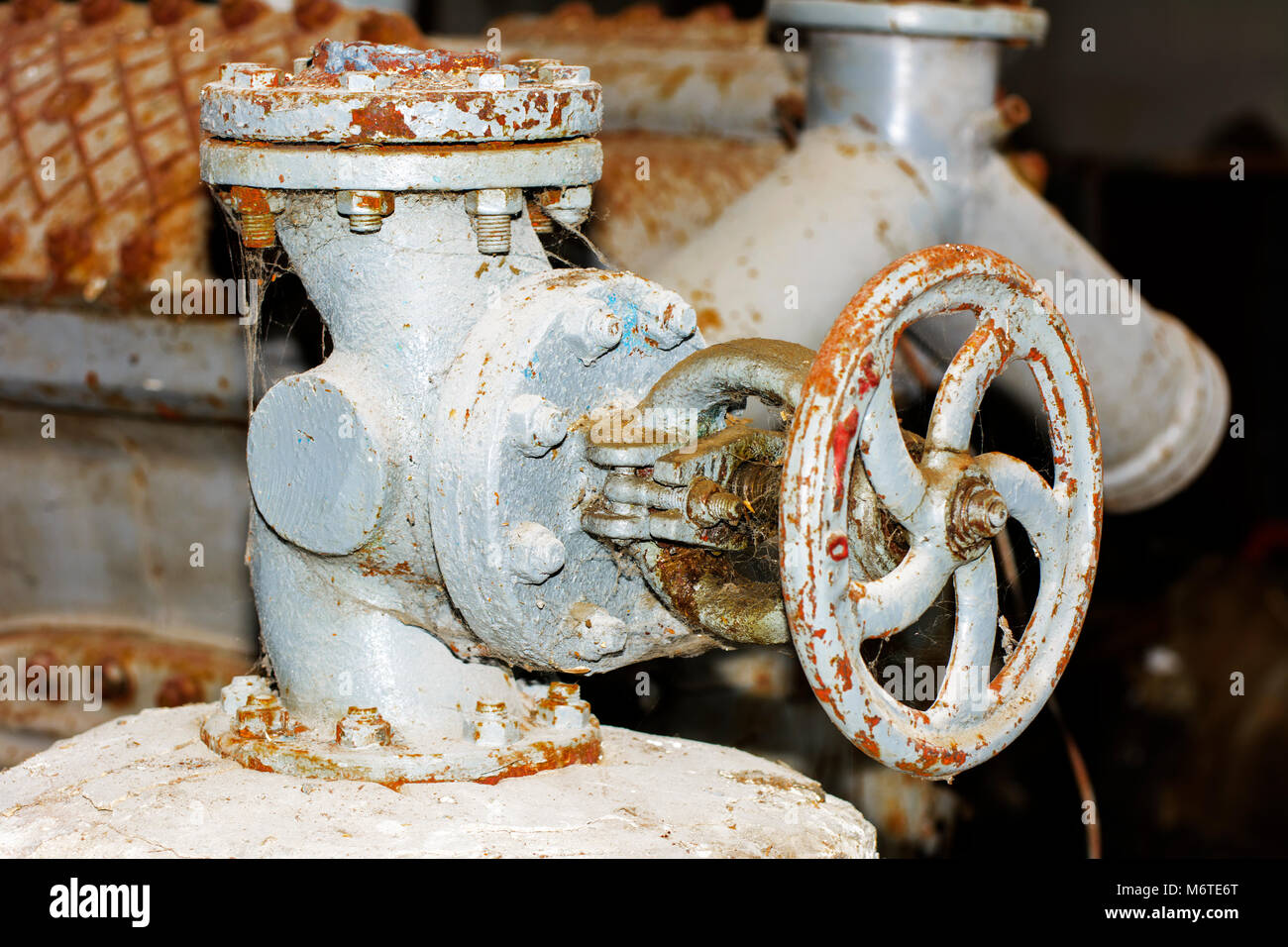Old and rusty shut-off valve and taps from equipment at an abandoned ...
