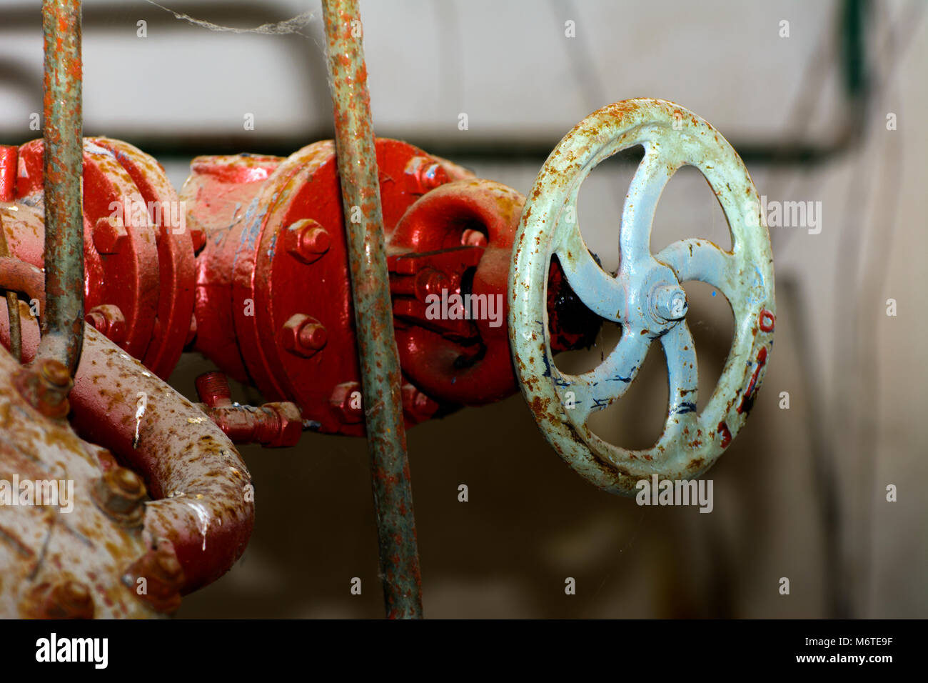 Old and rusty shut-off valve and taps from equipment at an abandoned ...