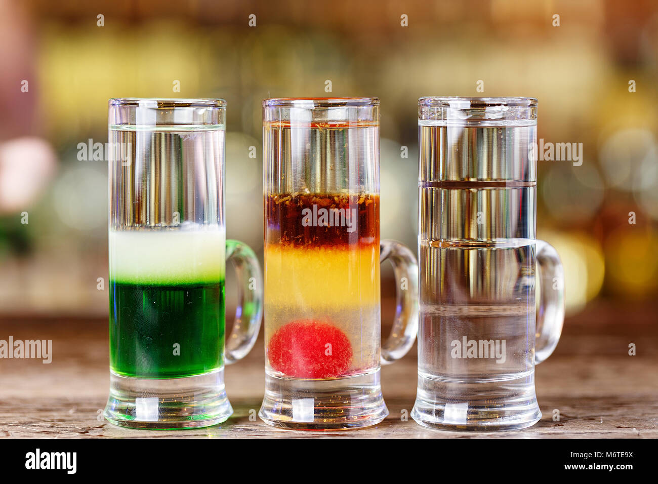 Multi-colored cocktails in a nightclub, alcoholic multi-layered ...