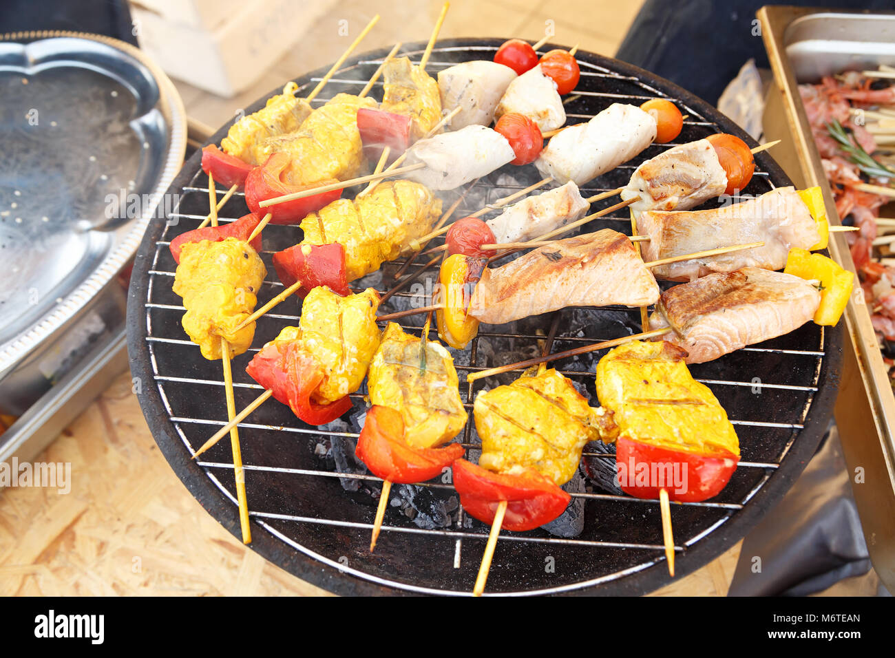 Cooked shish kebabs from fish with grilled vegetables, traditional ...