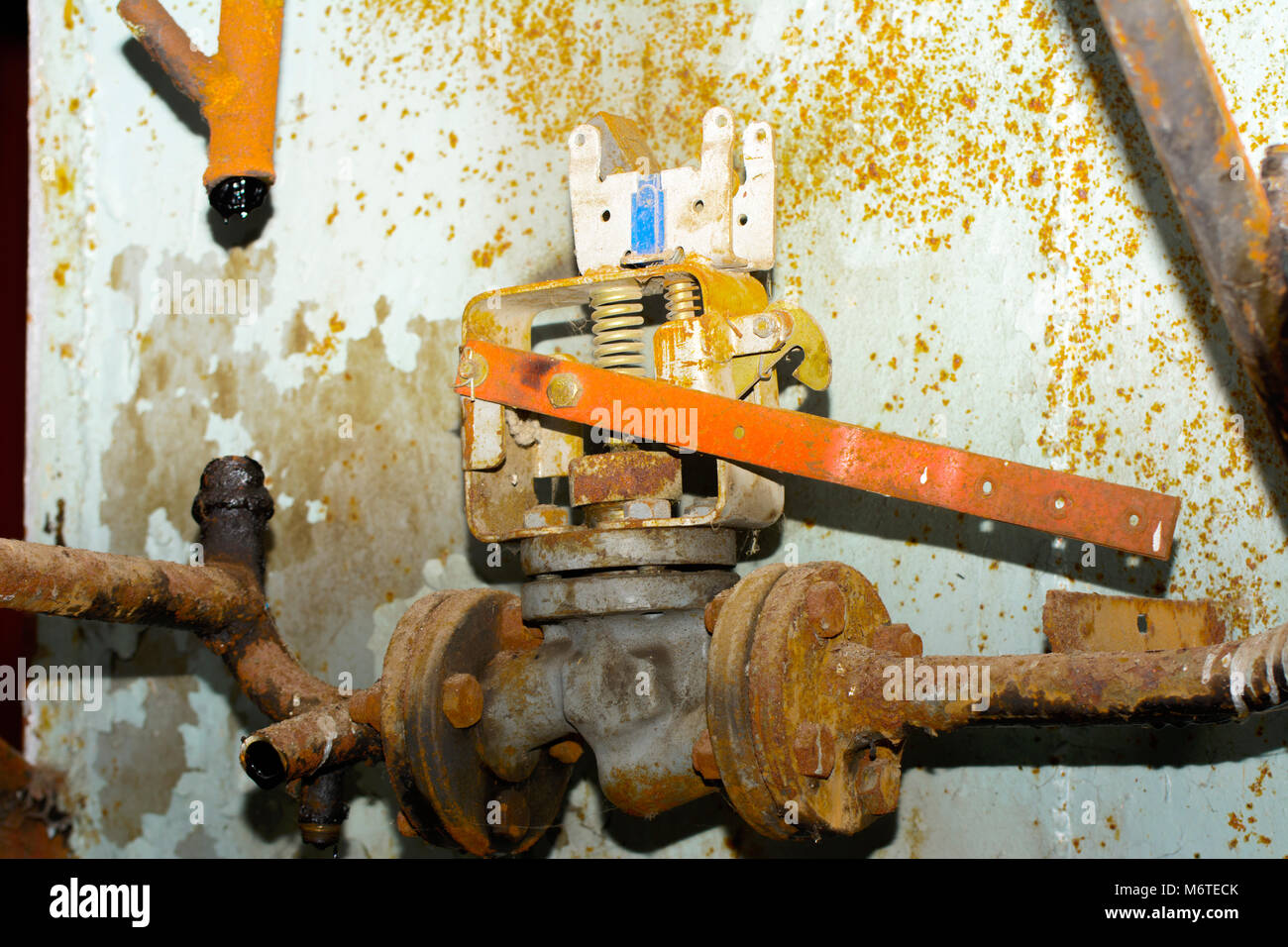 Old and rusty shut-off valve and taps from equipment at an abandoned ...